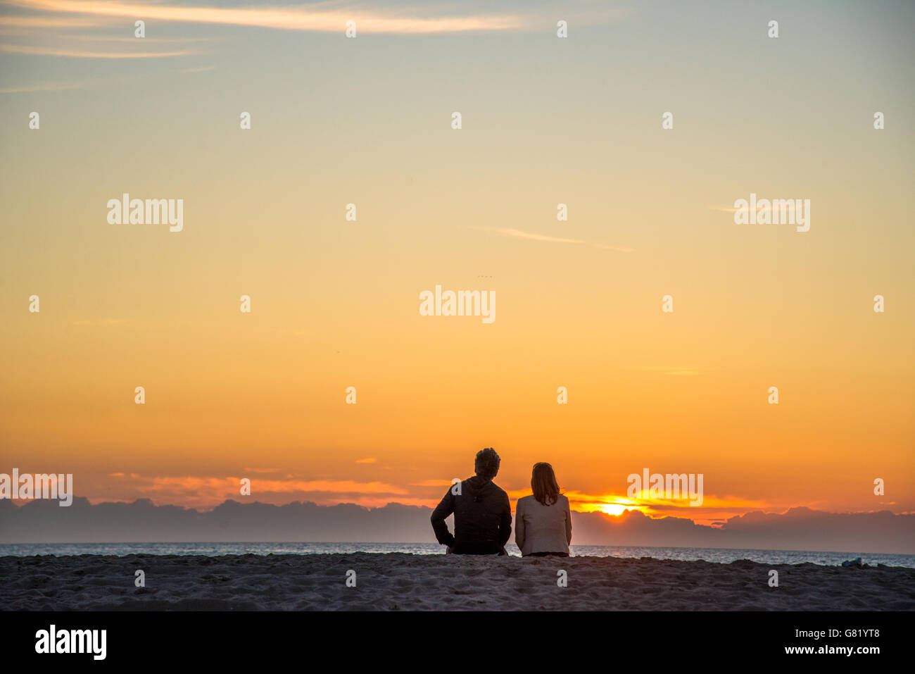 Man watching sunset at the beach hi-res stock photography and images ...