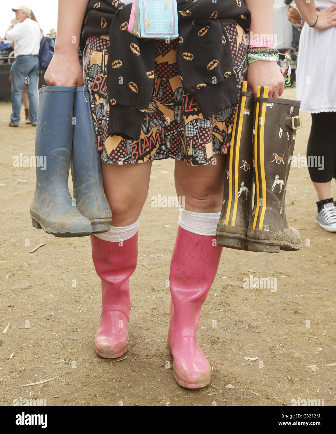 A festival goer carrying wellies at the Isle of Wight Festival, in ...