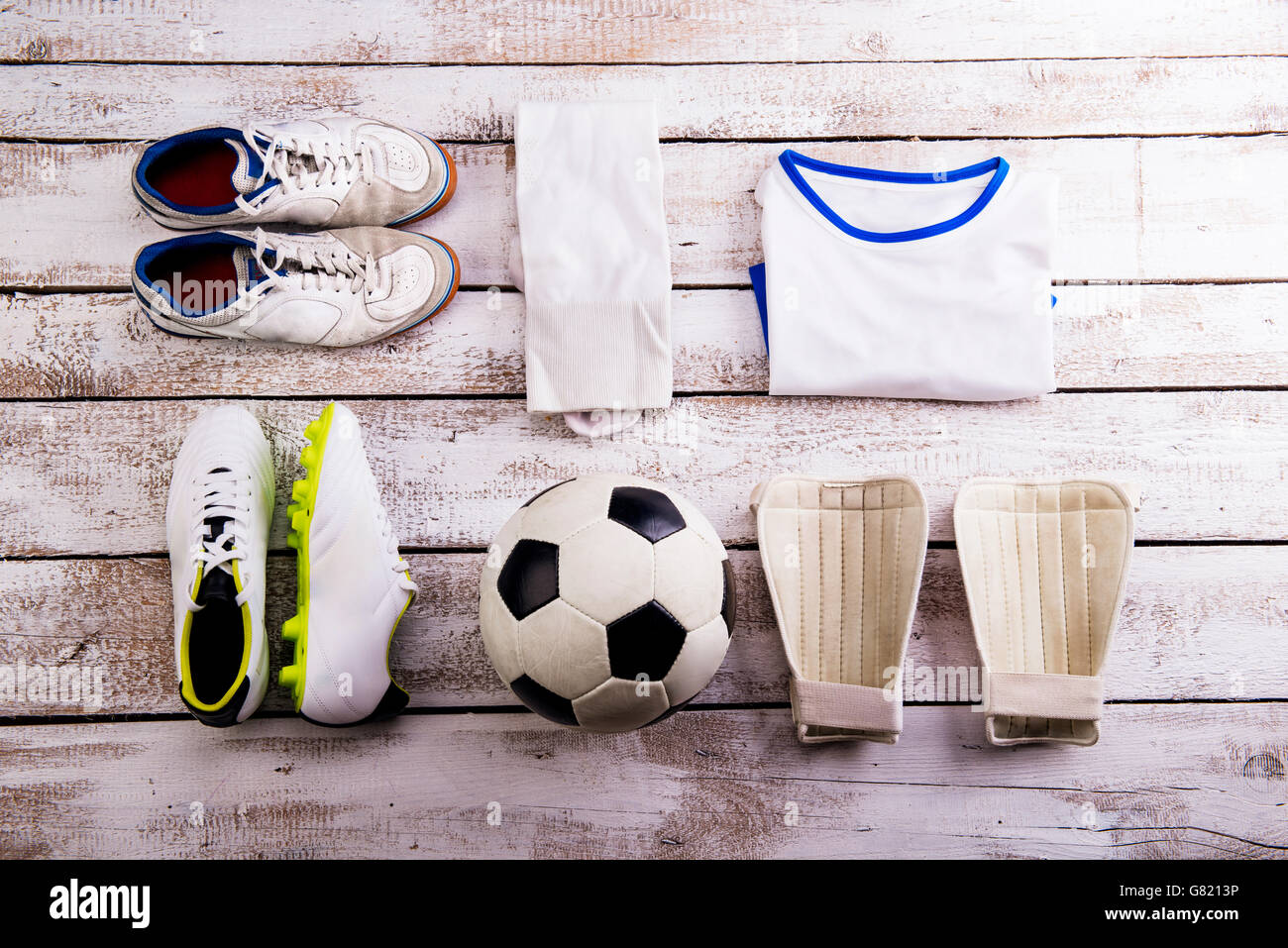 Soccer ball,cleats and various football stuff, wooden background Stock ...