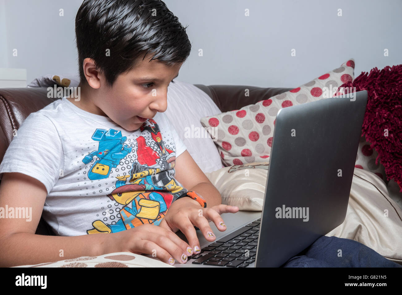 Young boy looking at computer hi-res stock photography and images - Alamy