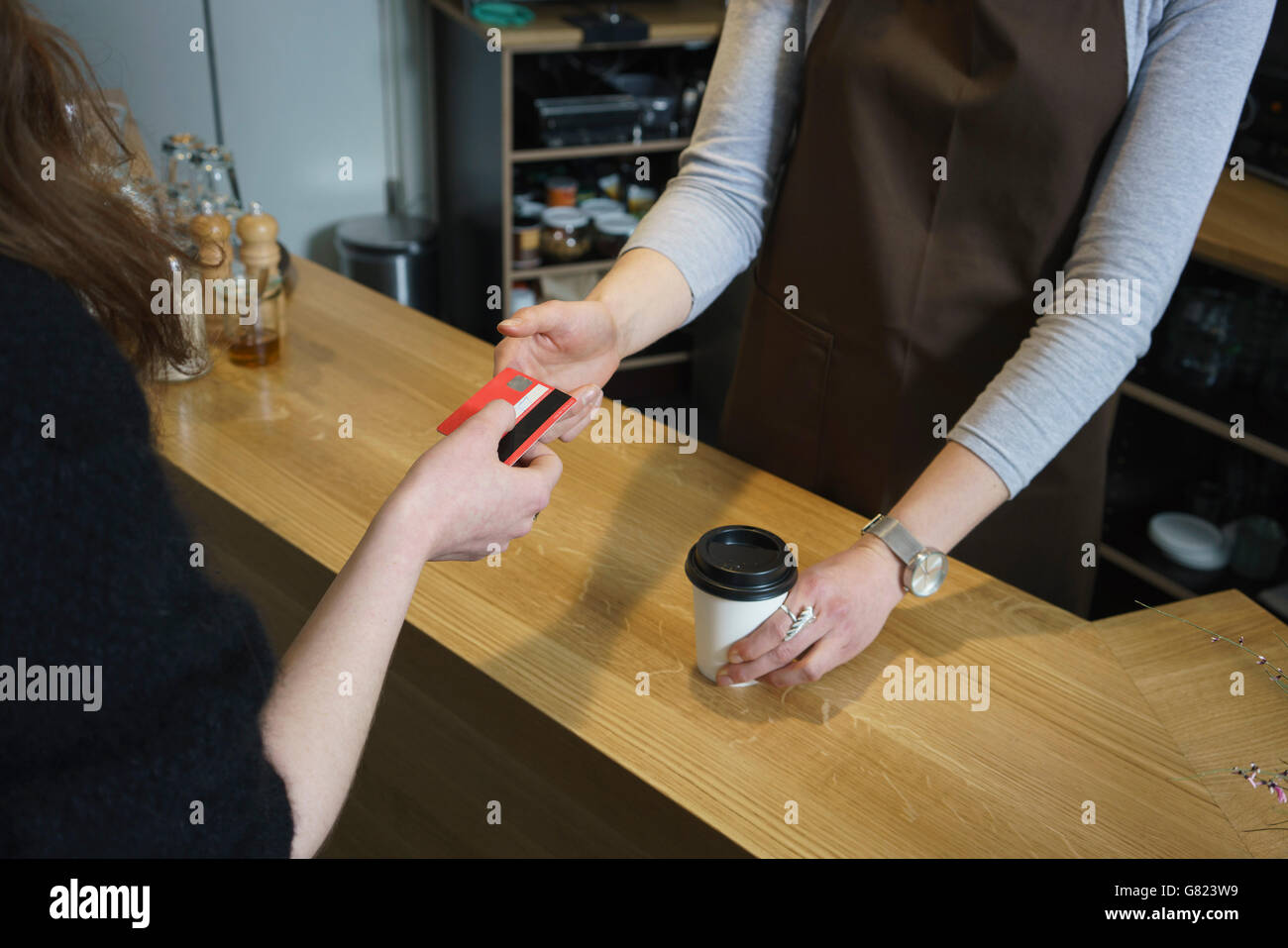 Woman paying coffee hi-res stock photography and images - Alamy