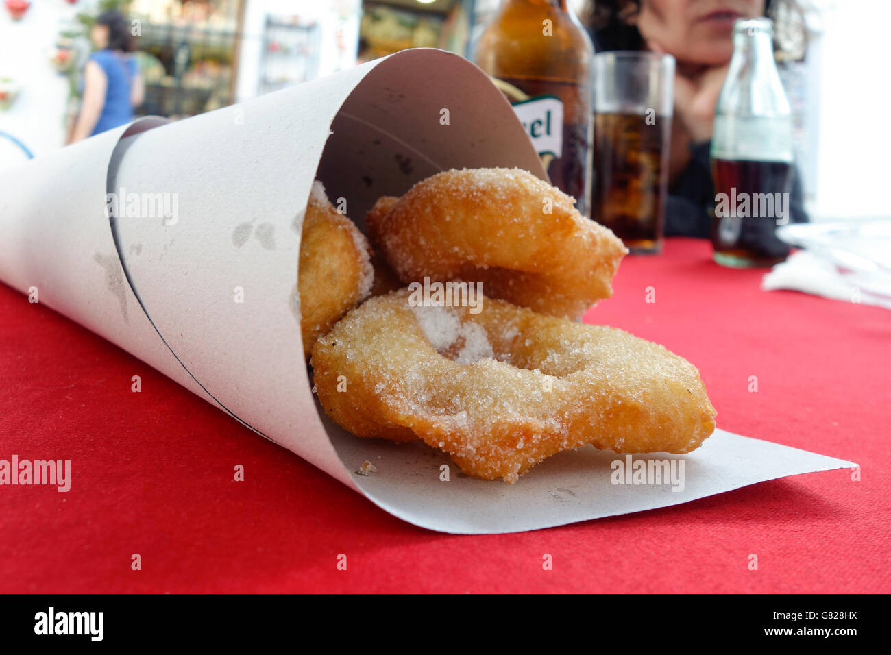 Typical spanish snack, buñuelos on table in paper cone. Spain Stock ...