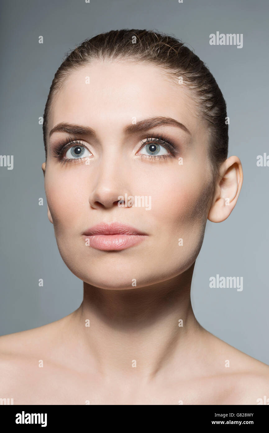 Beautiful woman against gray background Stock Photo - Alamy