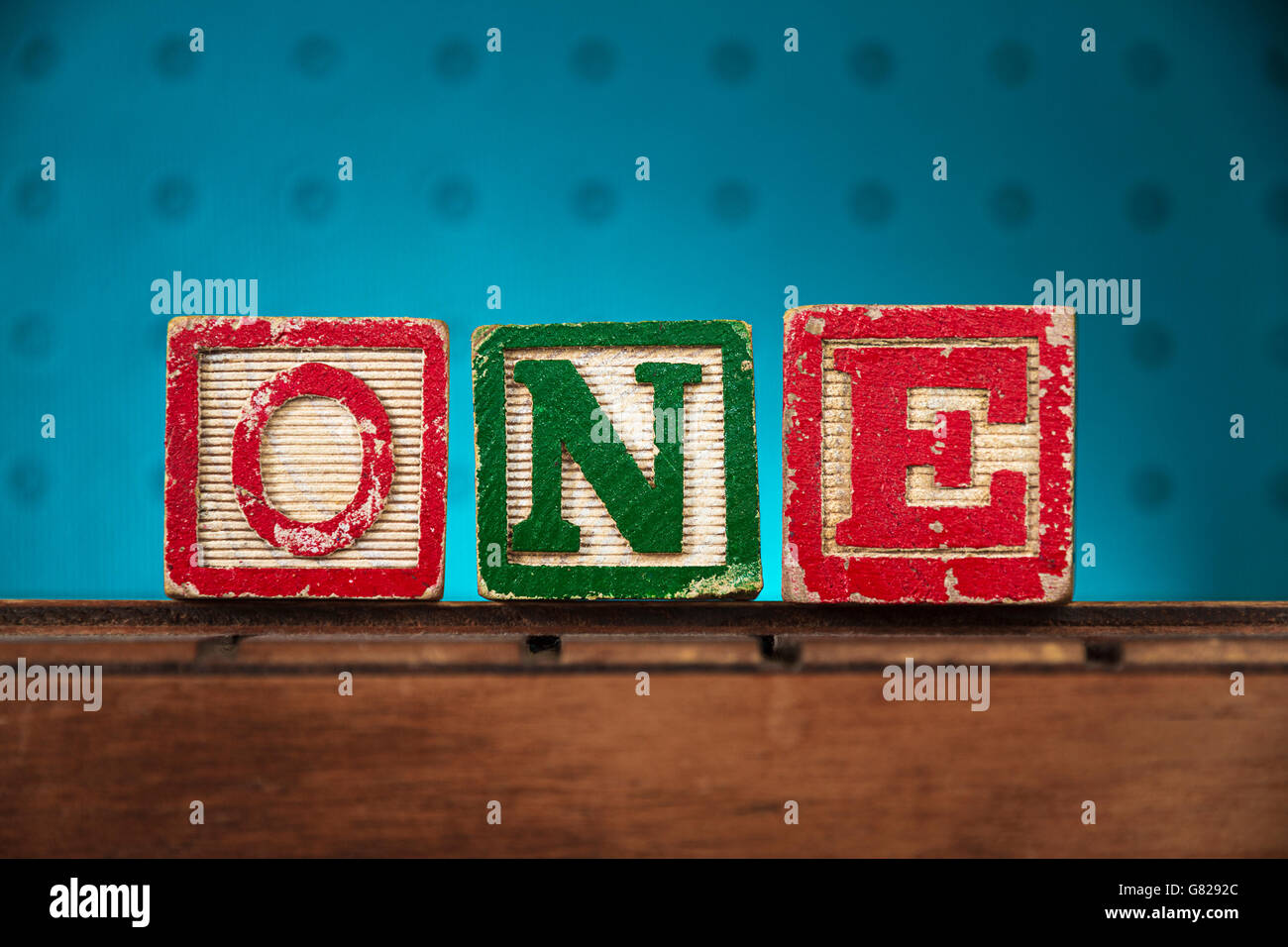 The word "one" spelled with letters on wooden toy blocks Stock Photo ...