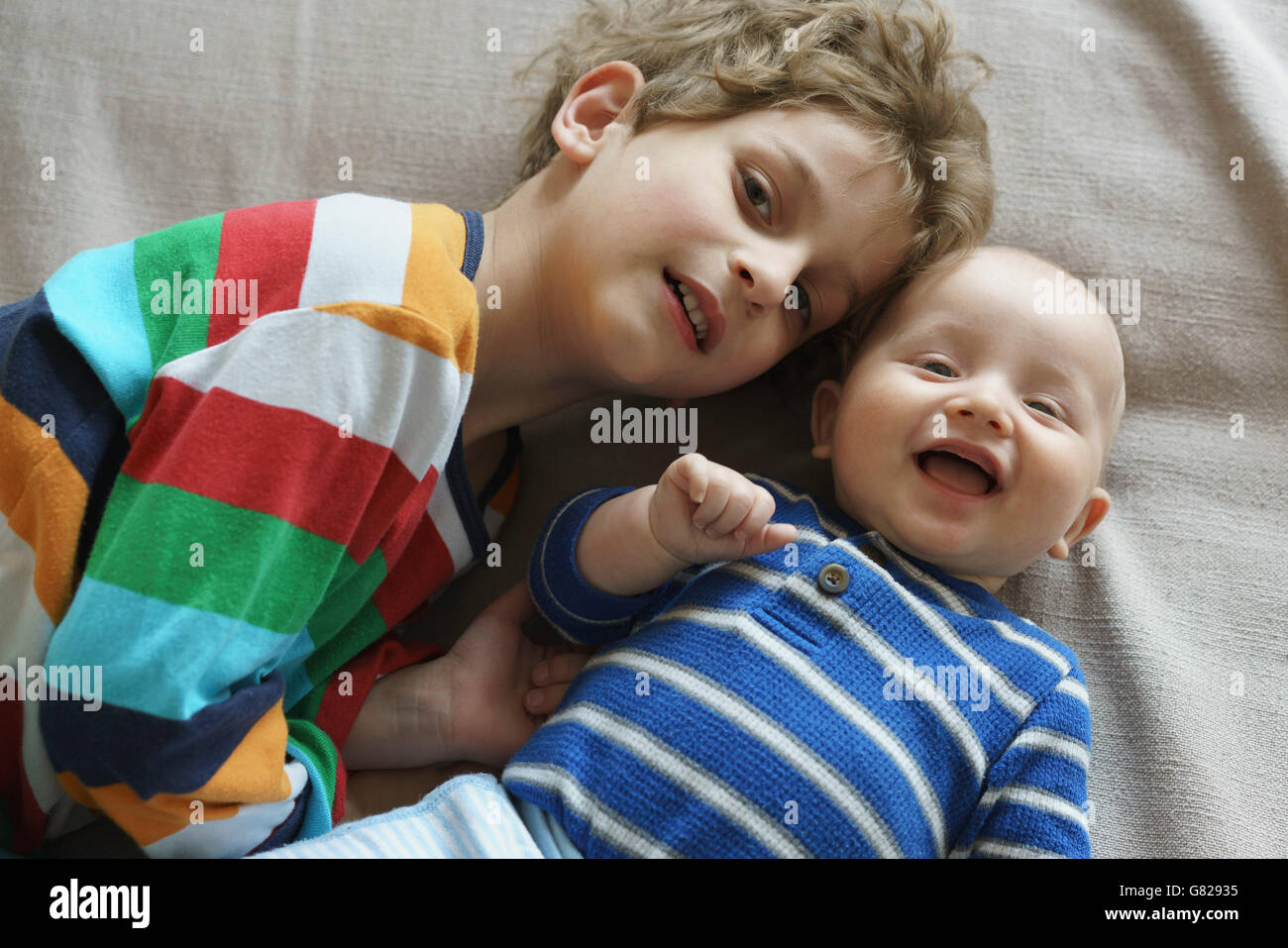 Two lying laughing brothers hi-res stock photography and images - Alamy