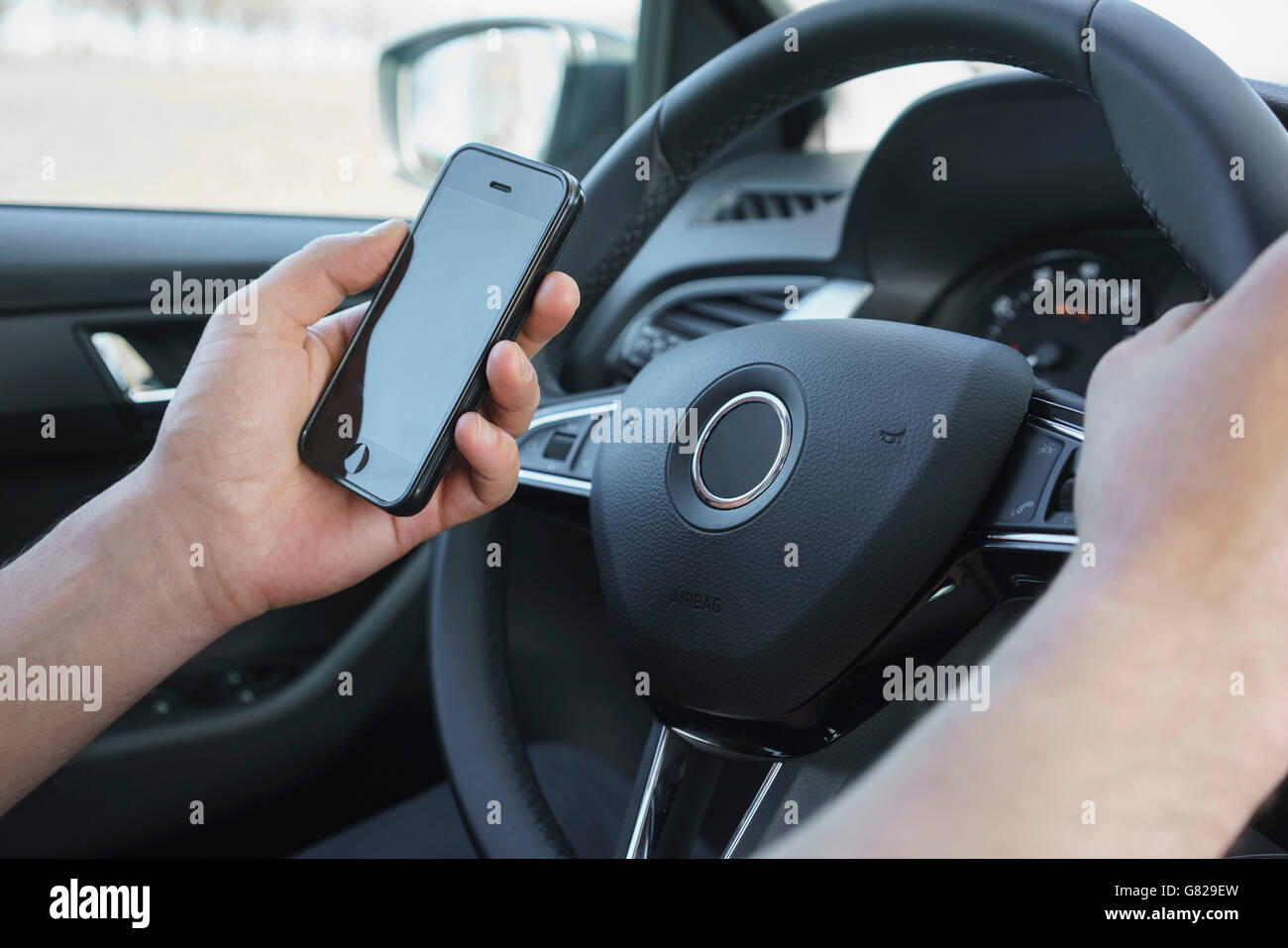 Cropped image of hand holding mobile phone while driving car Stock ...