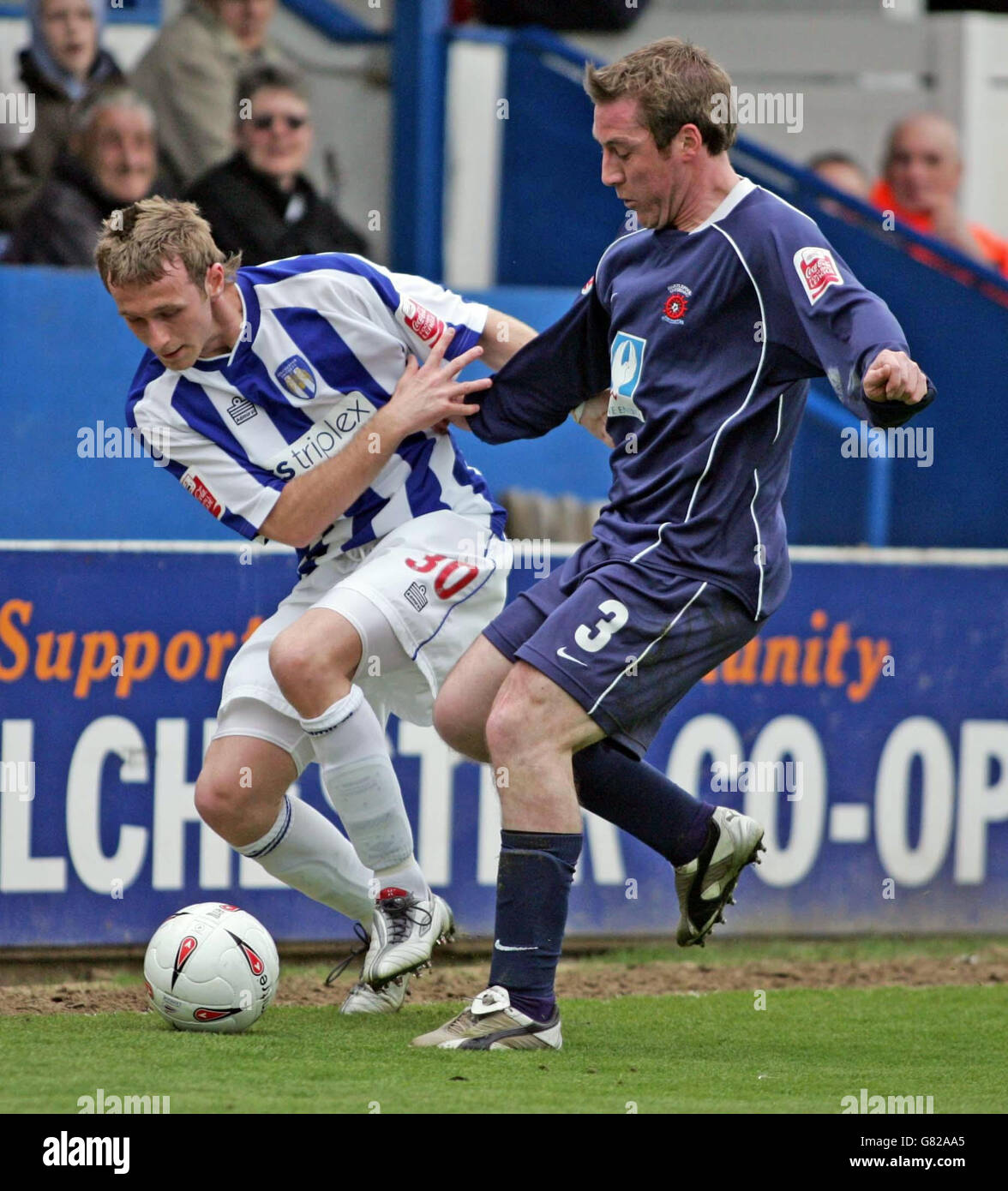 Colchester's Ryan Jarvis (L) and Hartlepool's Hugh Robertson battle for ...