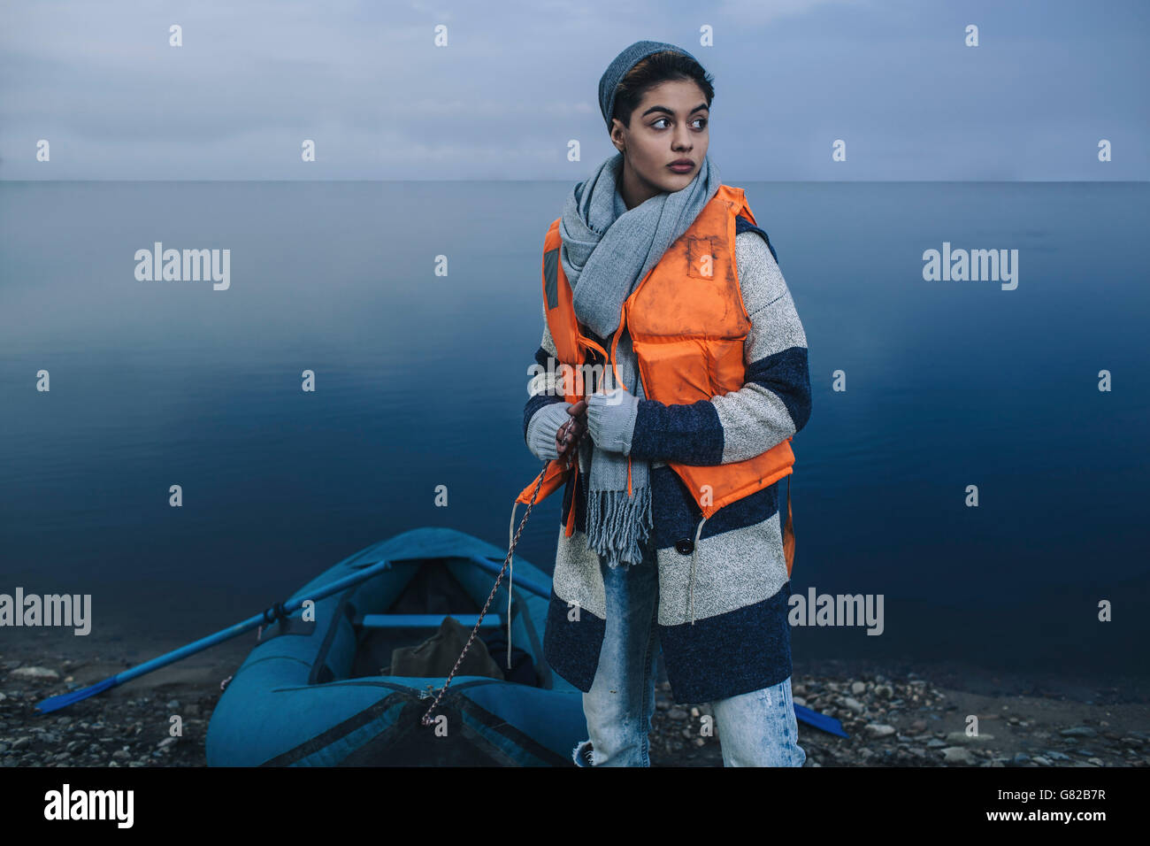 Teenage girl with inflatable raft standing on lake Stock Photo - Alamy