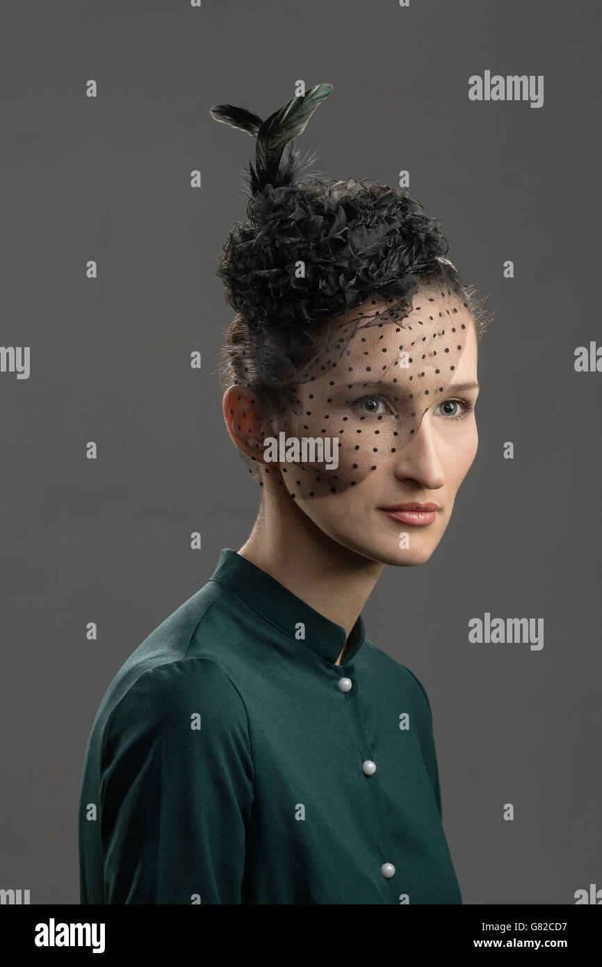 Woman with net covering face against gray background Stock Photo - Alamy