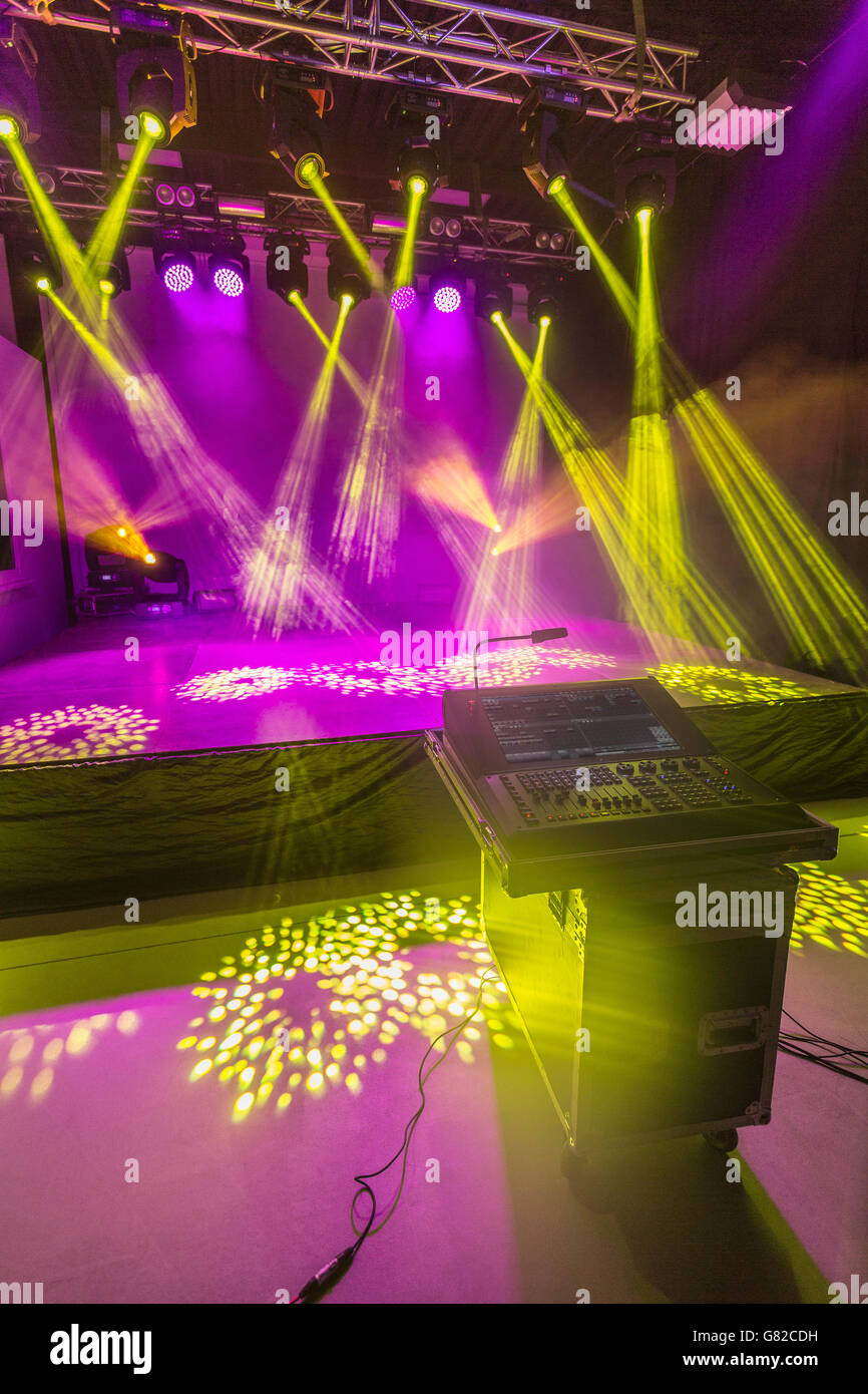 Sound mixer in front of illuminated stage in studio Stock Photo - Alamy