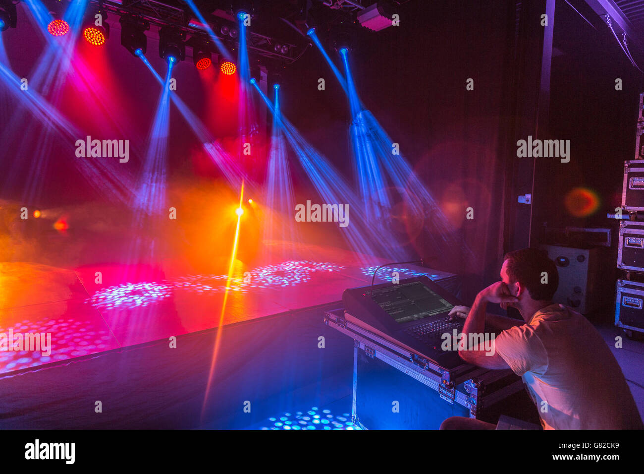 Man with sound mixer sitting by illuminated studio Stock Photo - Alamy