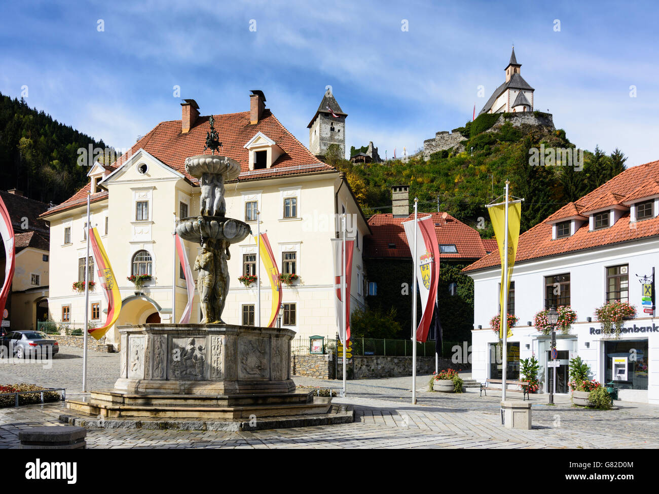 town hall , fountain and ruins Petersberg Castle, Friesach, Austria ...