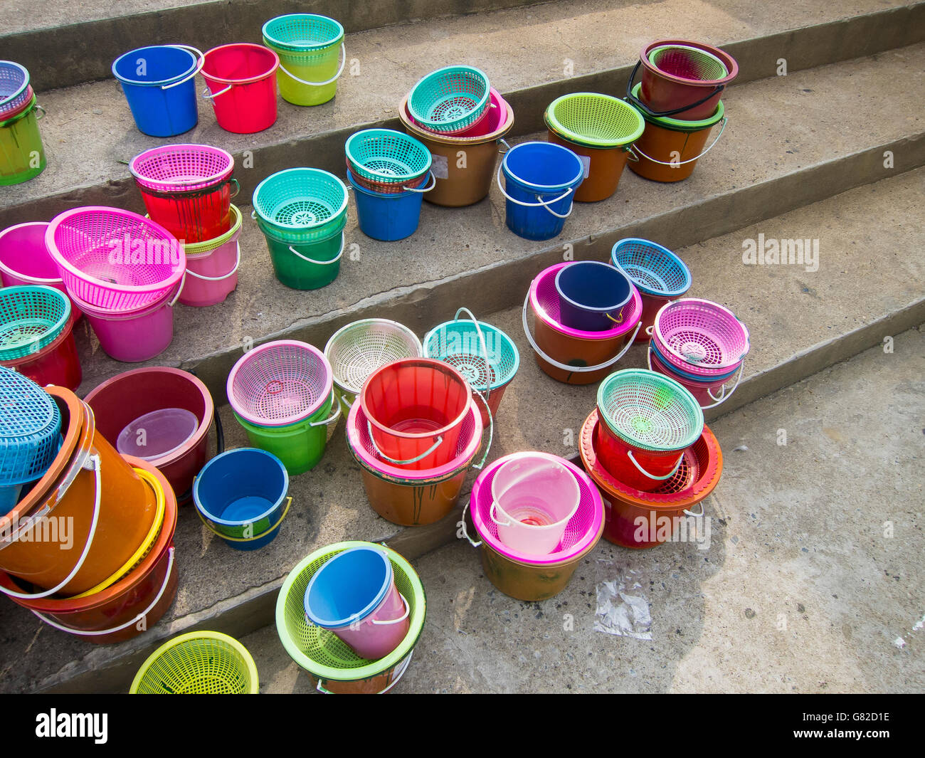 High angle view of colorful plastic baskets and buckets on steps Stock ...