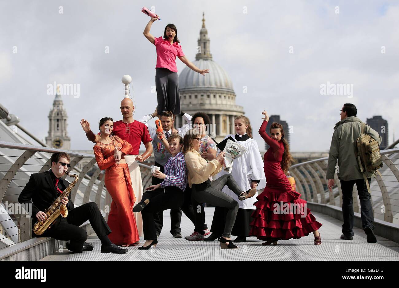 Performers gather during a photo call held on the Millennium Bridge ...