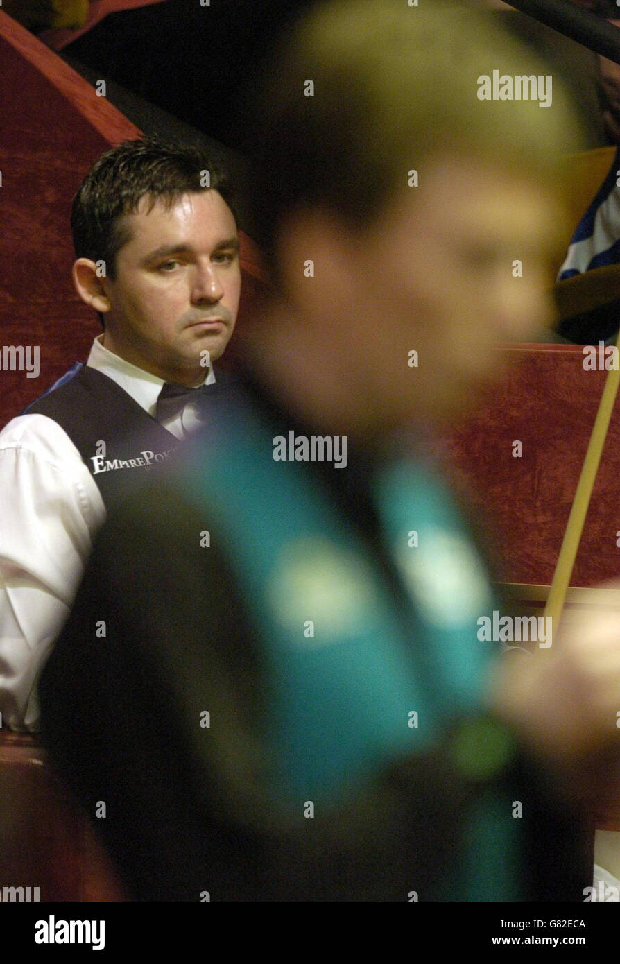 Alan McManus watches as Ken Doherty prepares to take his next shot ...