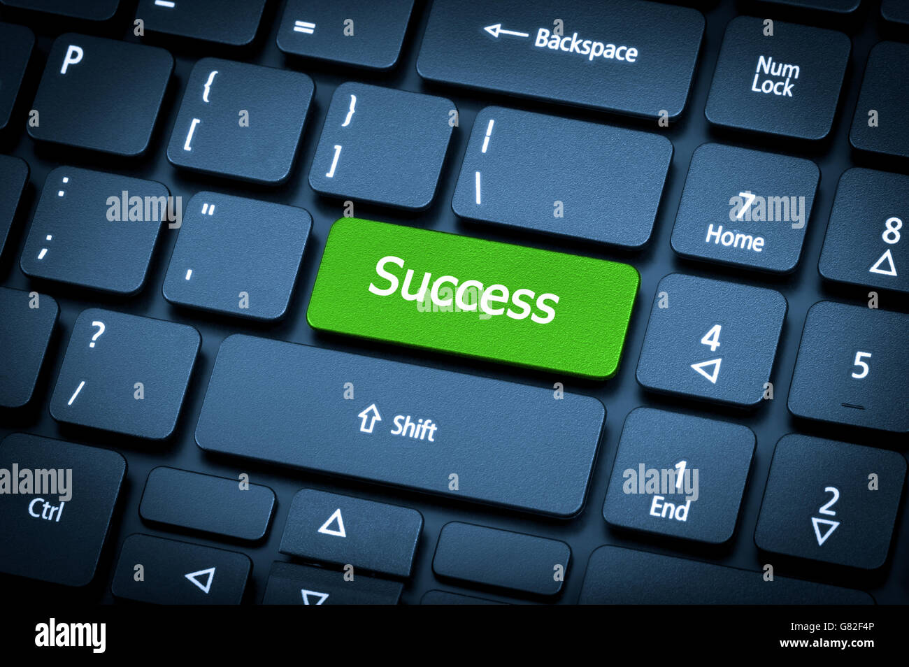 Close-up laptop keyboard. The focus on the Success key. Toning is blue ...