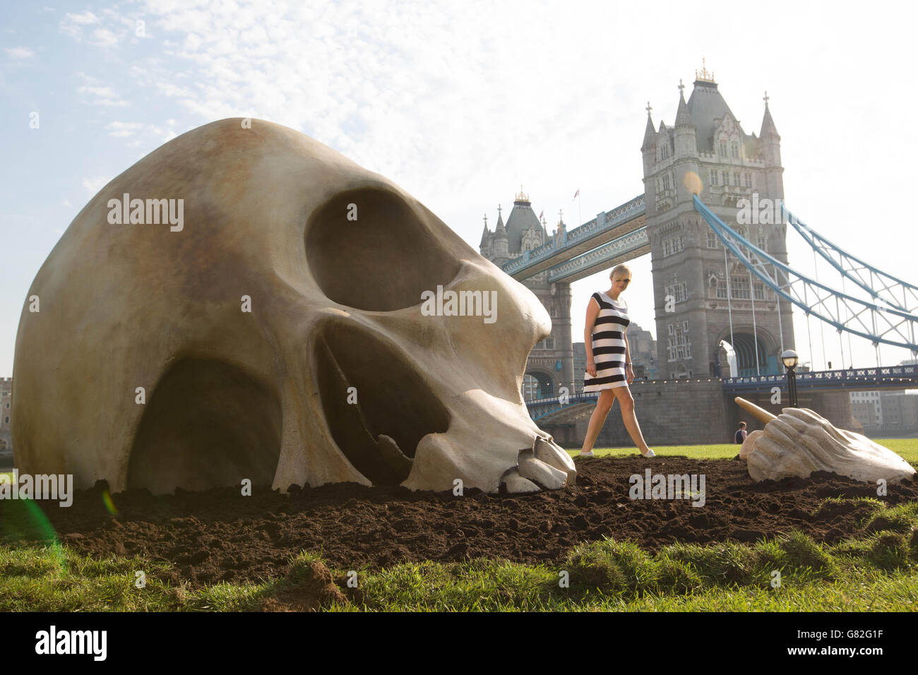 EDITORIAL USE ONLY A passer-by inspects a 2.5m tall model of a human ...