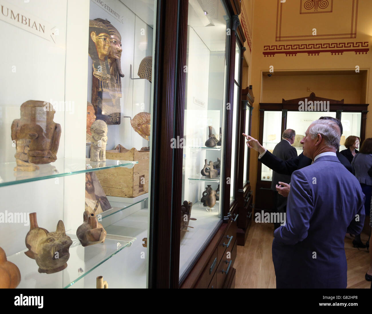 The Prince of Wales views historic artifacts during a visit to Eton ...