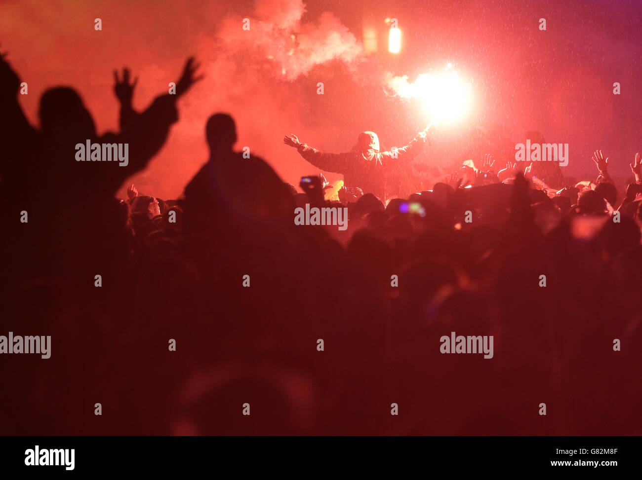 A flare is lit up in the crowd watching the Prodigy performing on the ...