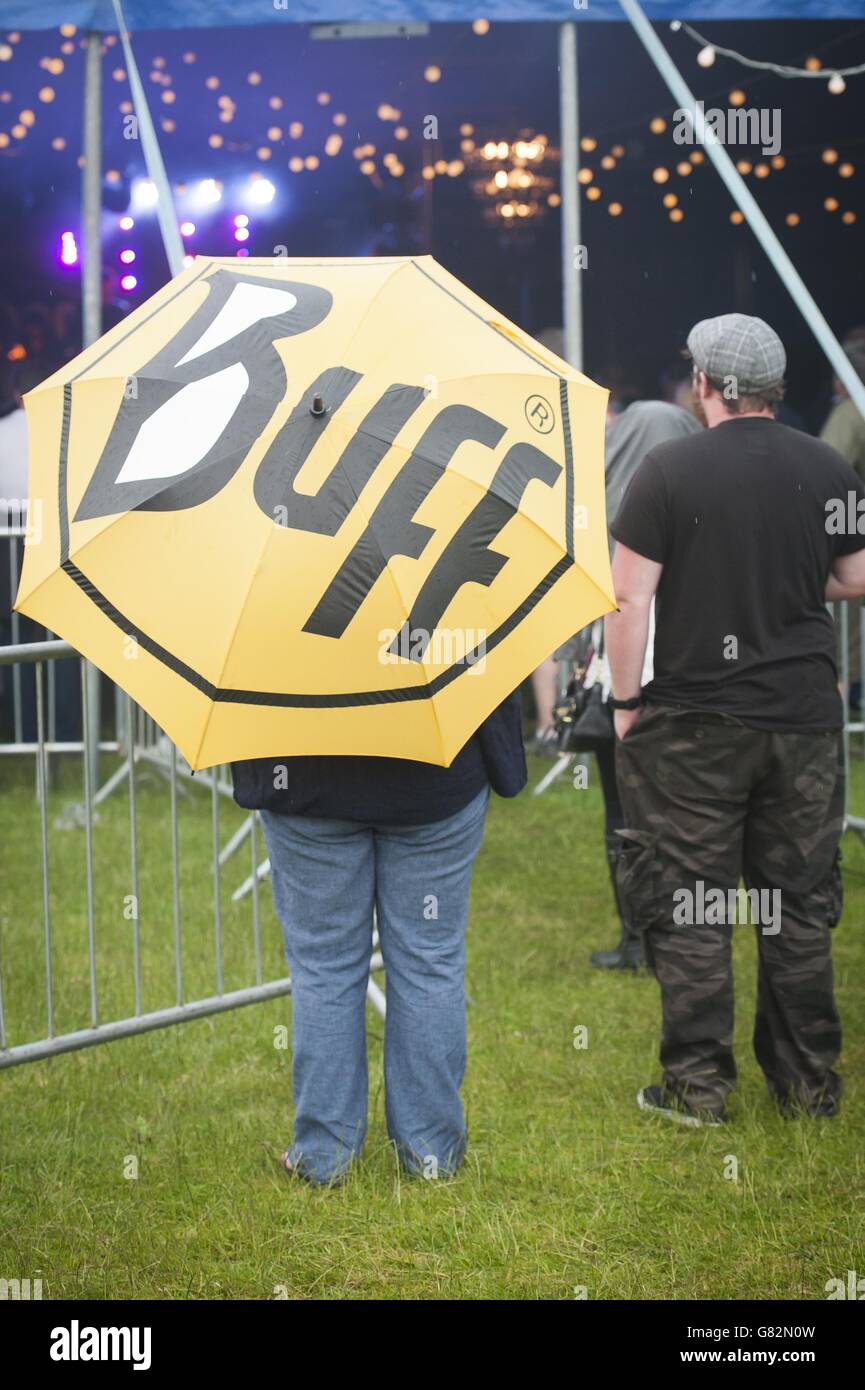 Festival goer with a giant Buff umbrella on day one of the Isle of ...