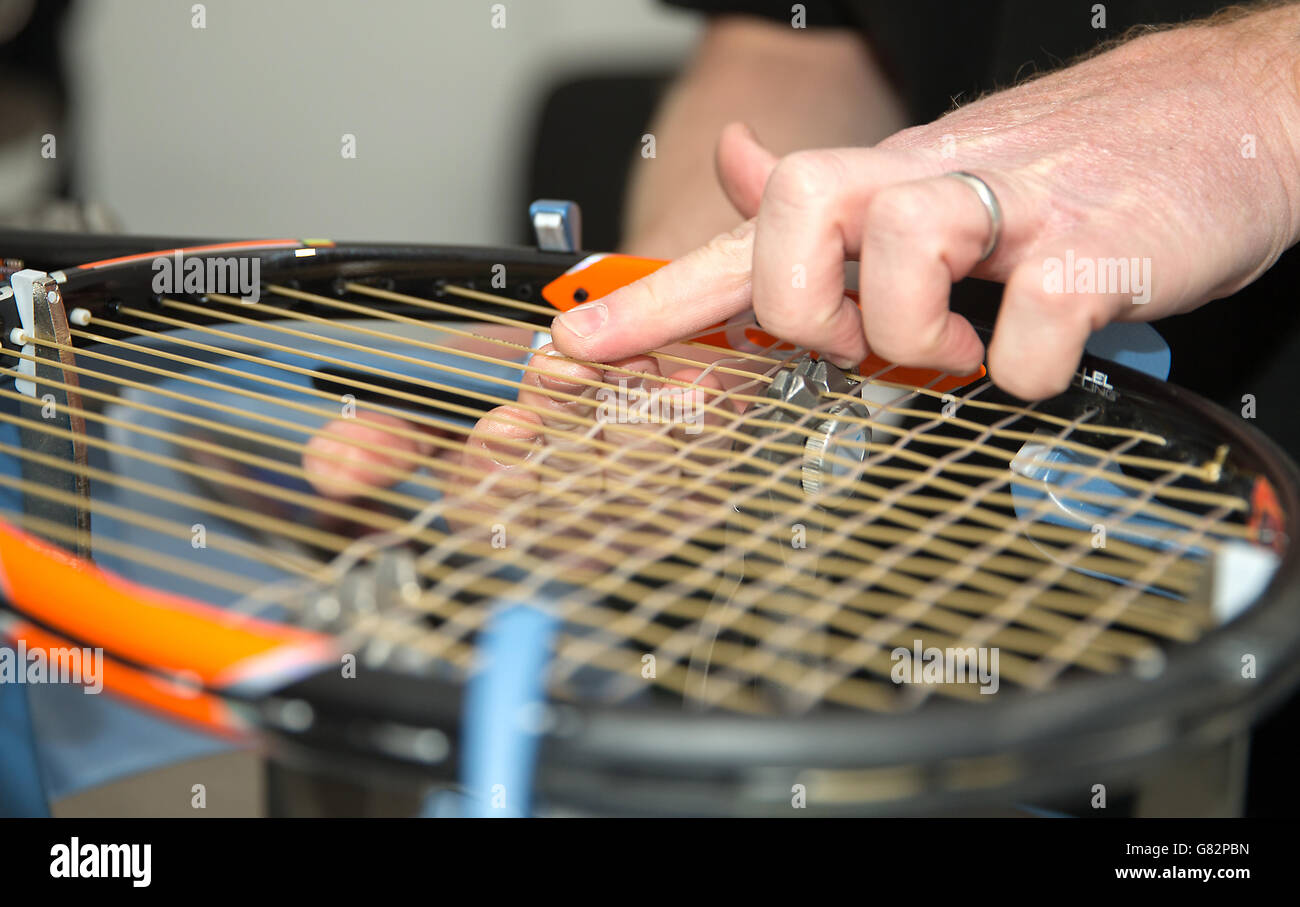 A stringer re-strings a tennis racquet at the request of a player Stock ...