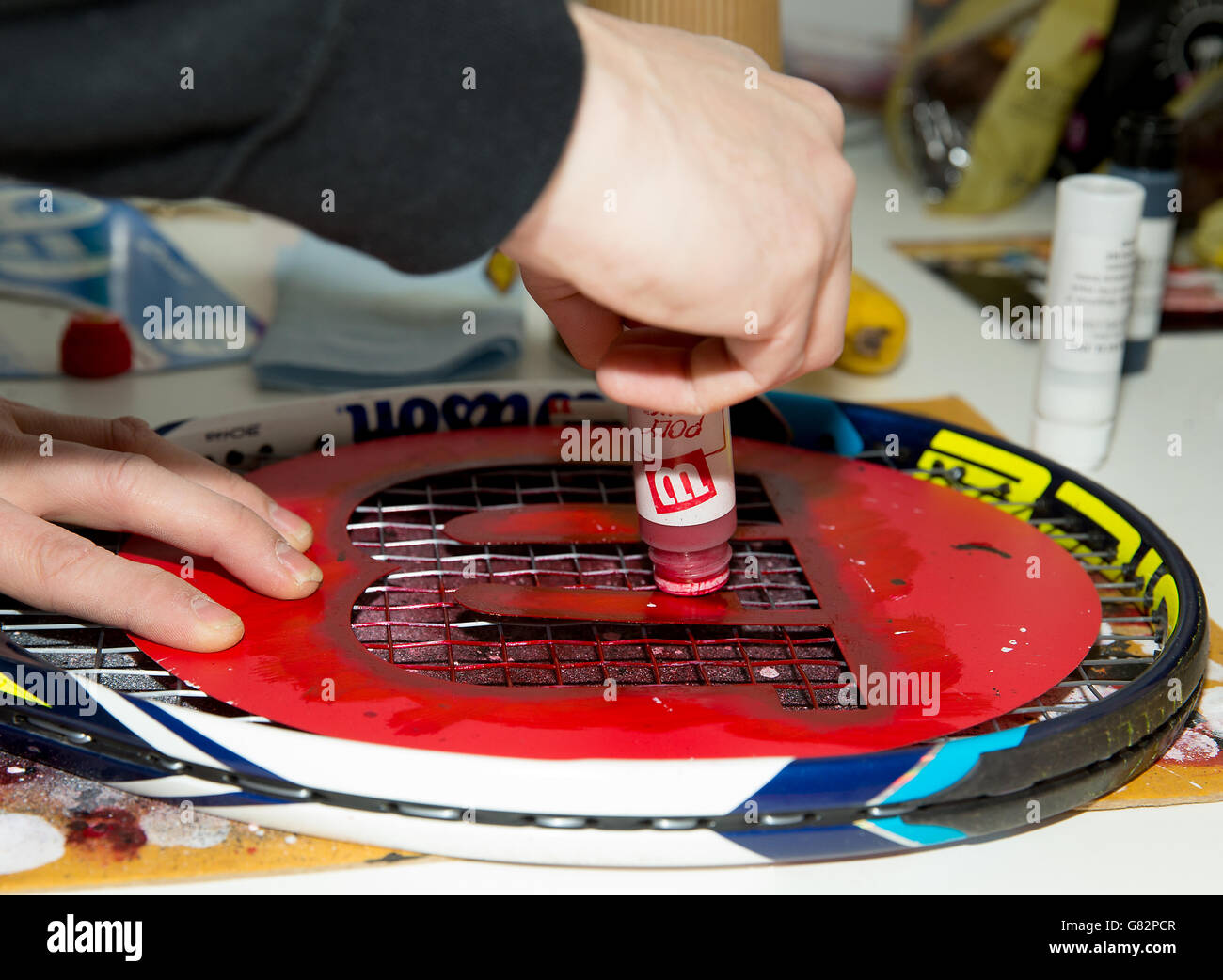 A stringer re-brands a tennis racquet after re-stringing it Stock Photo ...