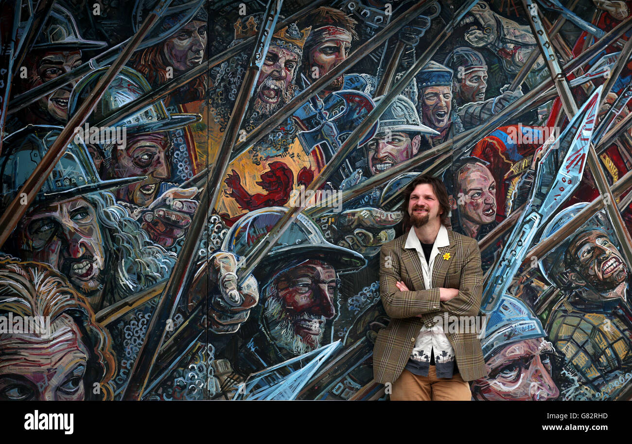Artist Chris Rutterford poses with a mural that he created for the ...