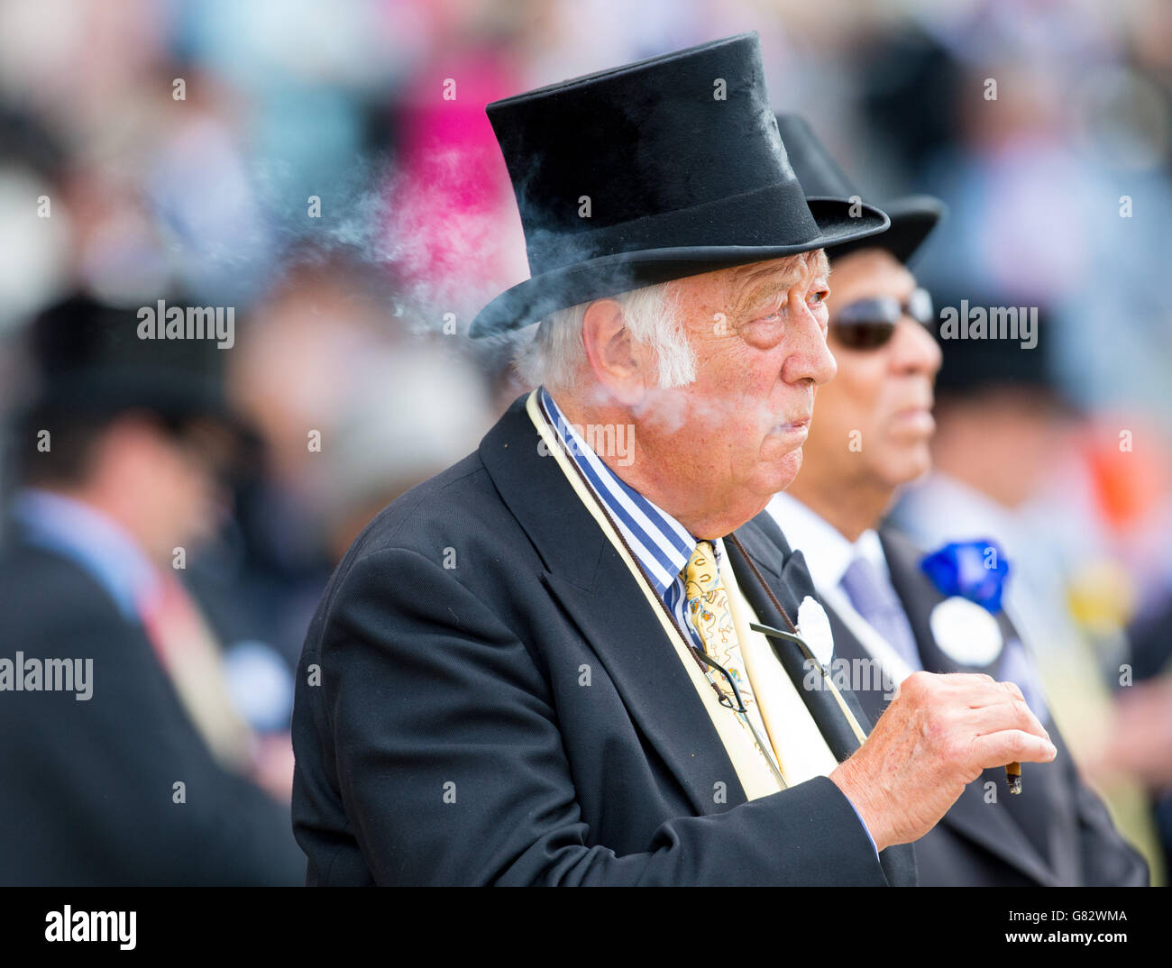 A racegoer in the Royal Enclosure smokes a cigar during day two of the ...