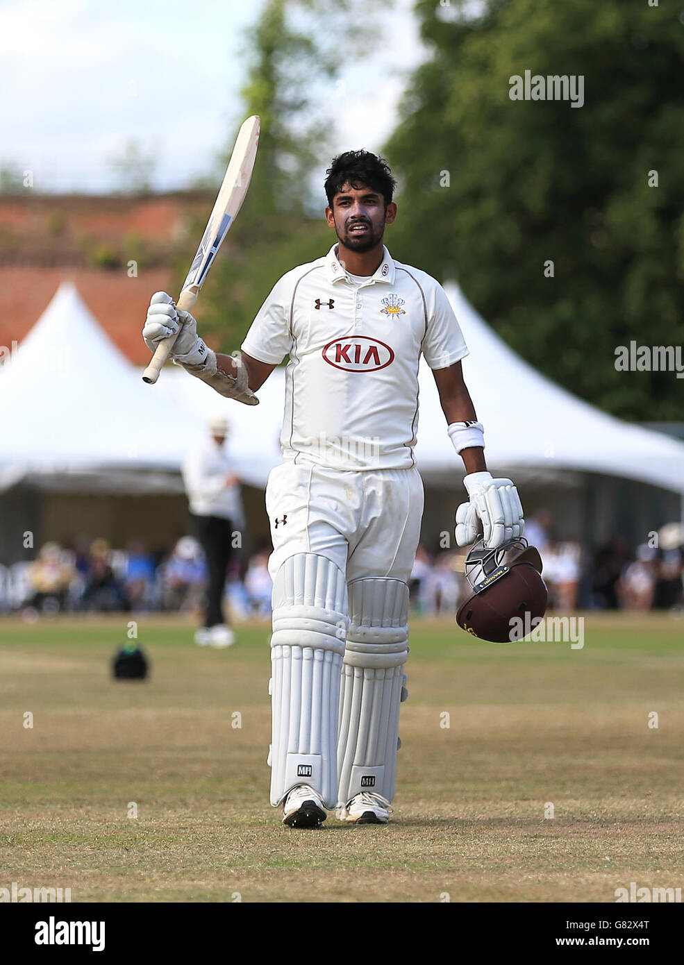 Surrey's Arun Harinath raises his bat after completing his second ...