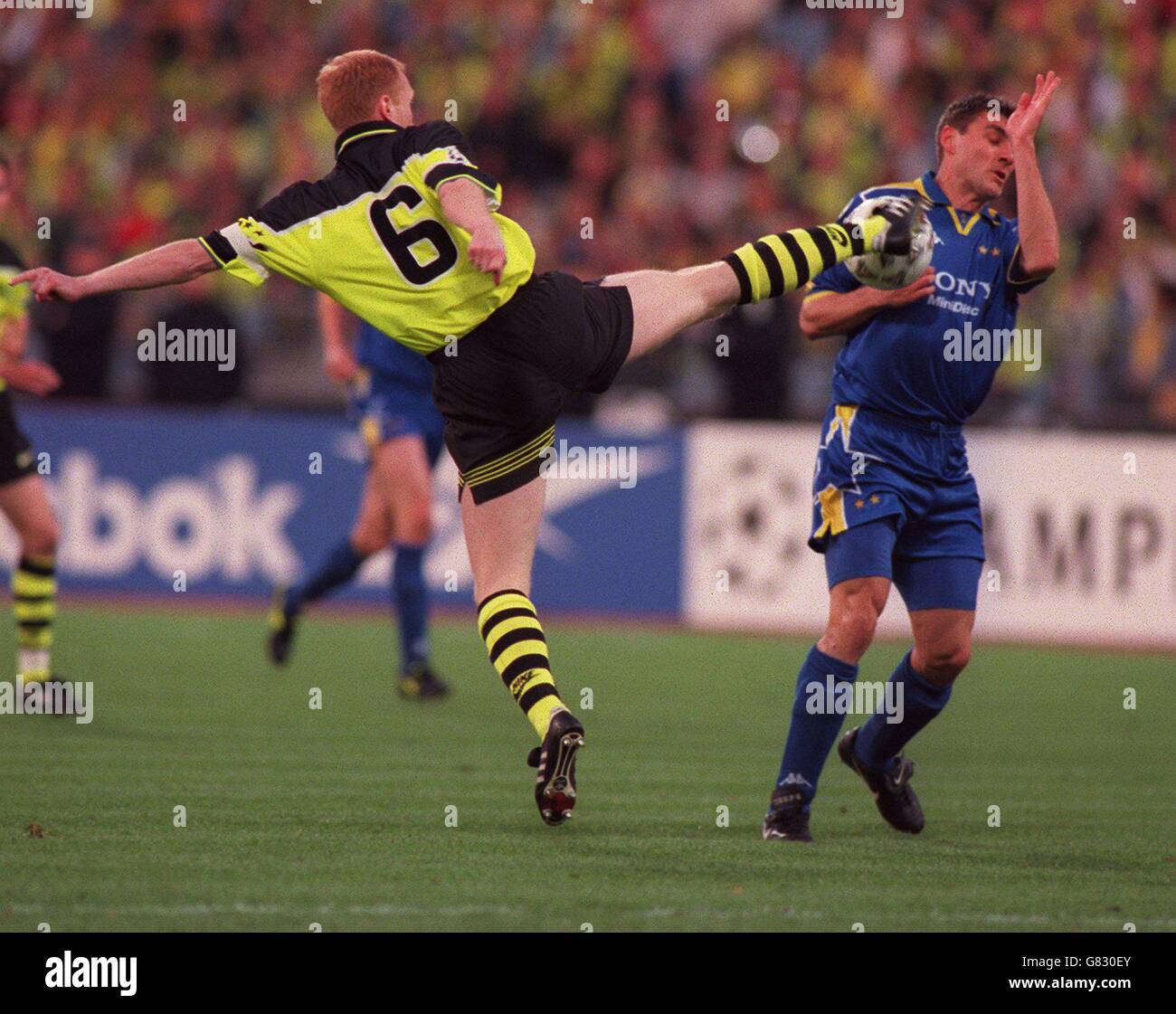 Matthias Sammer of Borussia Dortmund (left) aims a kick at Juventus's ...