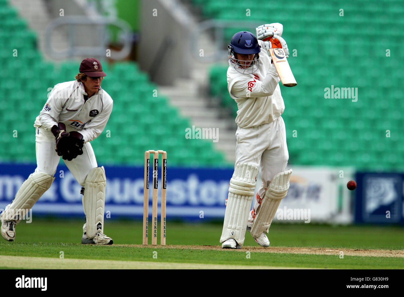 Surrey's Jonathan Batty looks on as Sussex's Michael Yardy clocks up ...