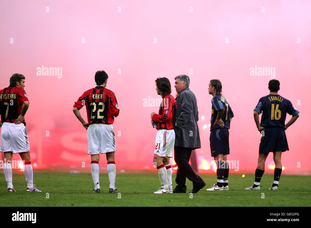 Inter Milan's and AC Milan's players stand around after flares were ...