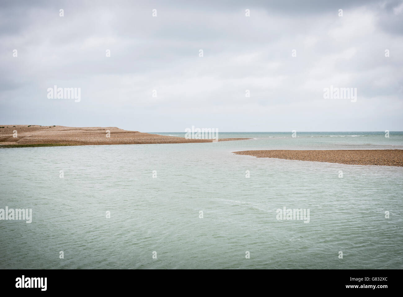 The shingle spit at the entrance to Pagham harbour near Chichester ...