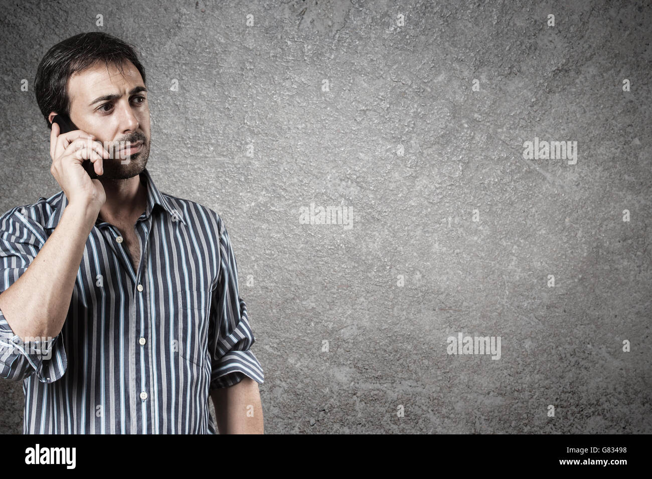 Portrait of man listening a phone call Stock Photo - Alamy