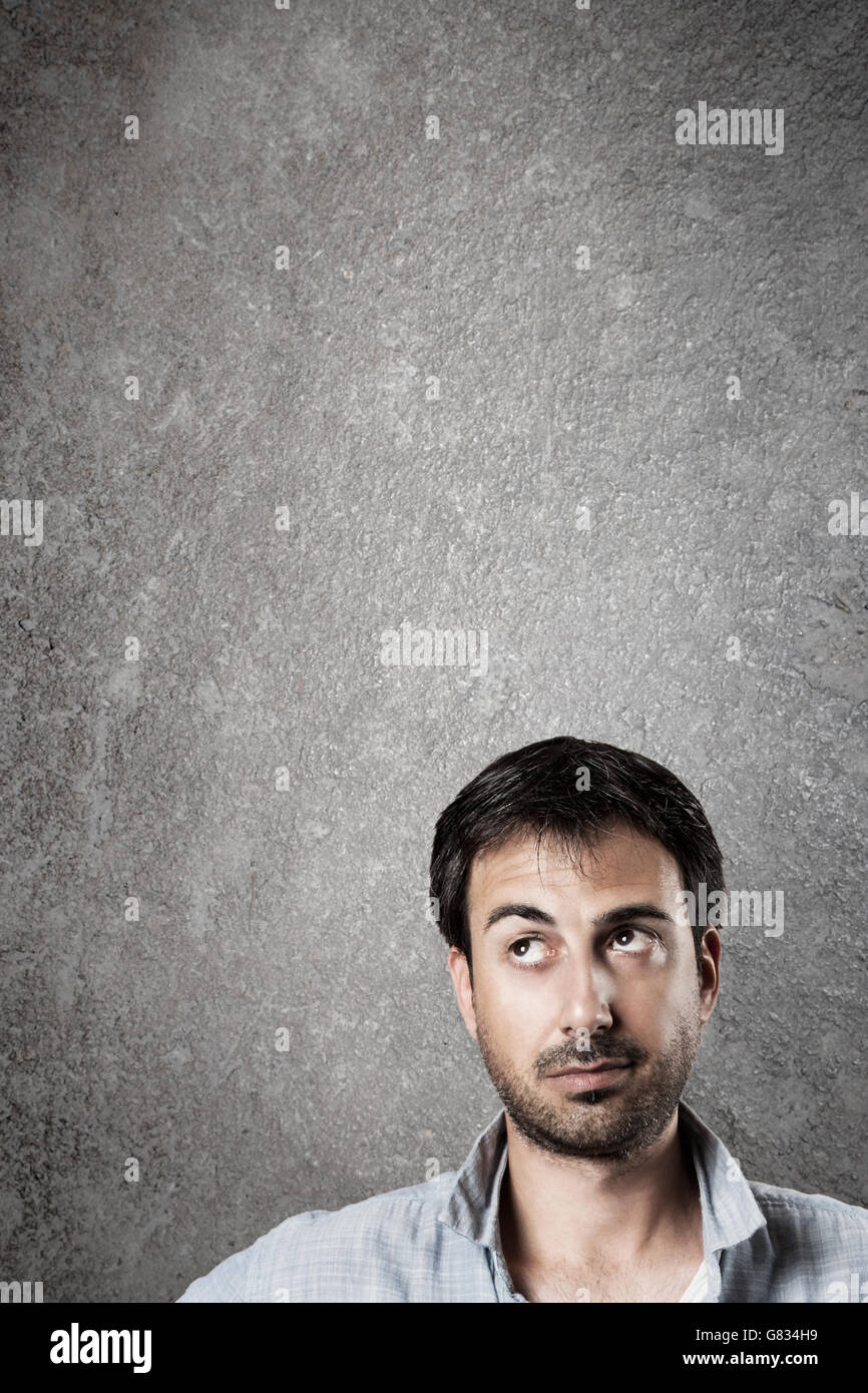 Man expectantly looking up with raised eyebrow. Vertical image Stock ...