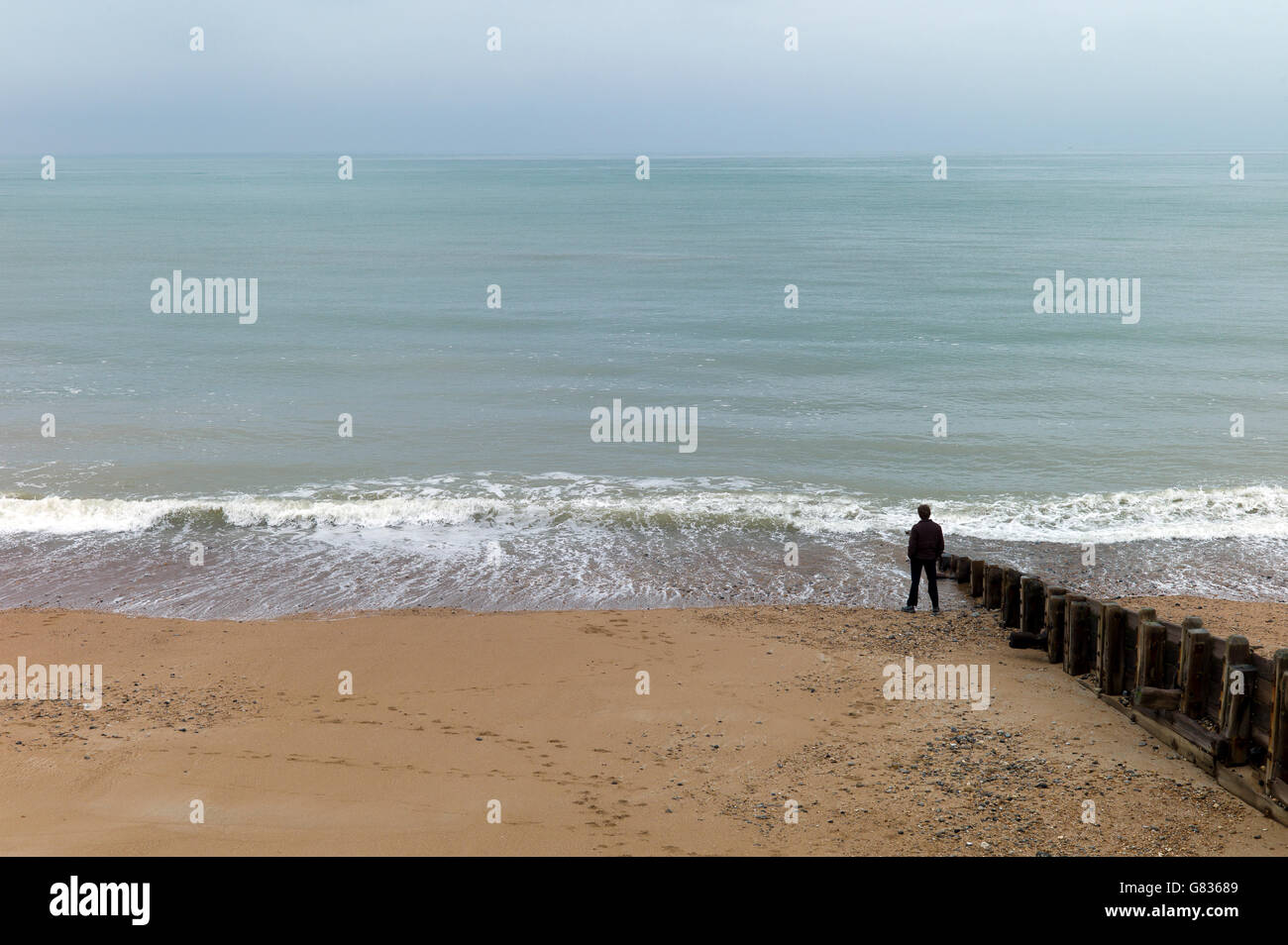 lone man standing on seashore. Brighton, UK Stock Photo - Alamy