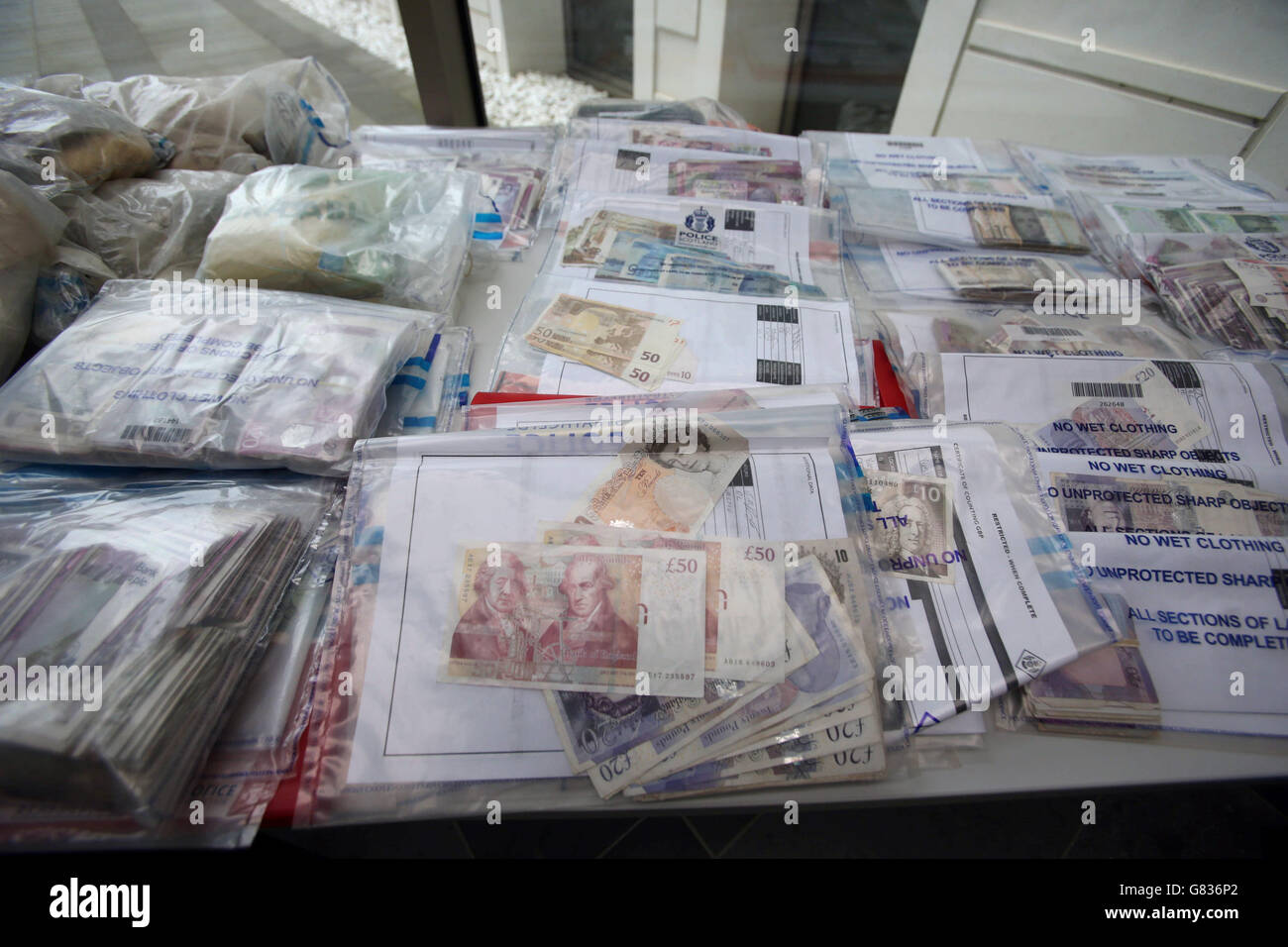 Cash seized in raids on display during a press briefing at the Scottish ...
