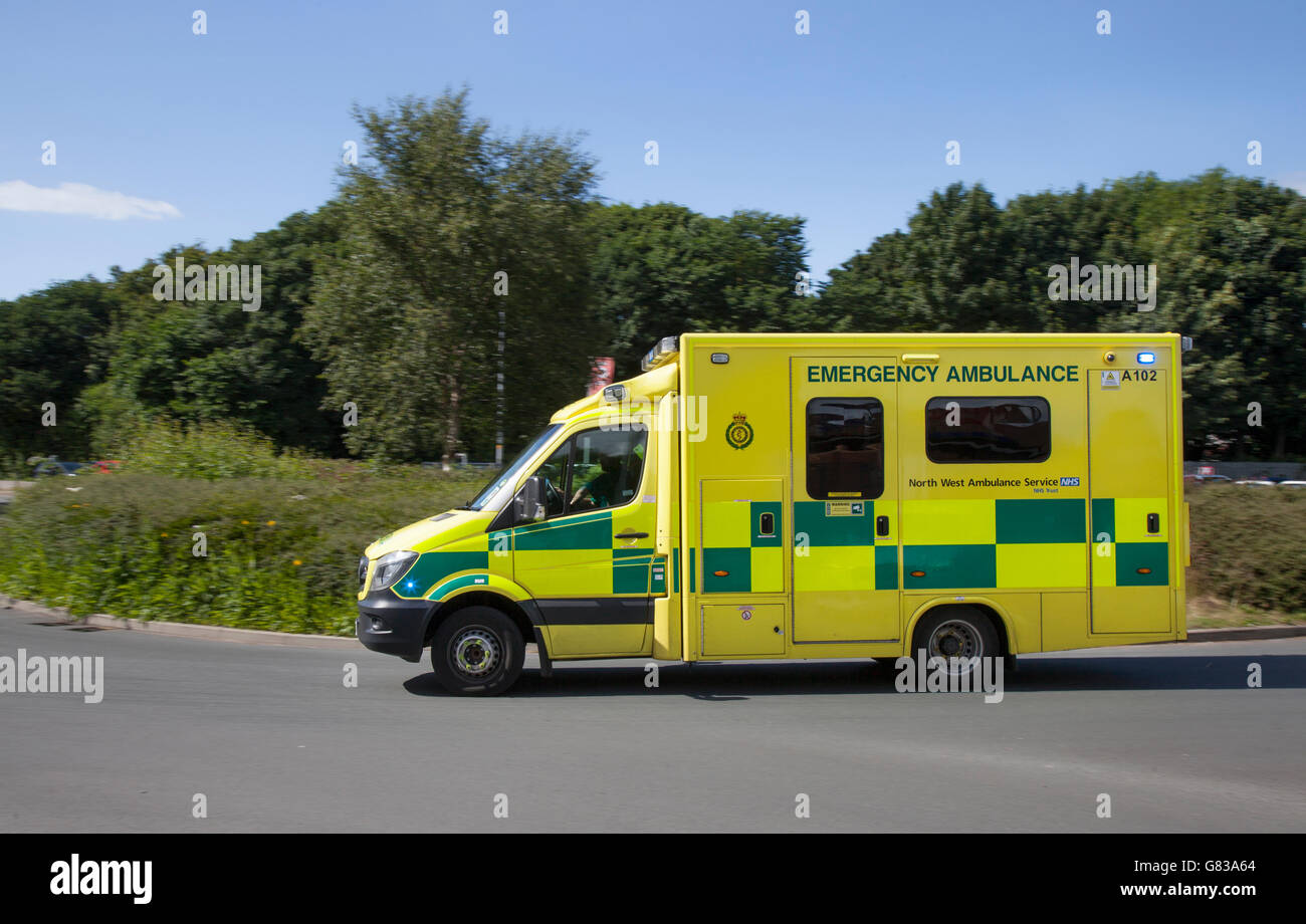 NHS National Health Service Northwest Emergency ambulance on roundabout ...
