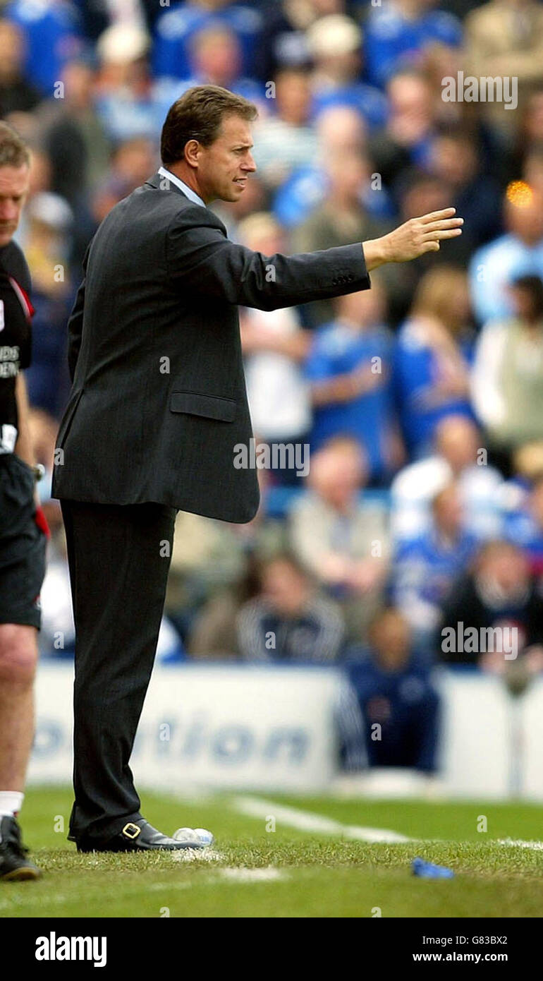Portsmouth manager Alain Perrin instructs his players from the ...