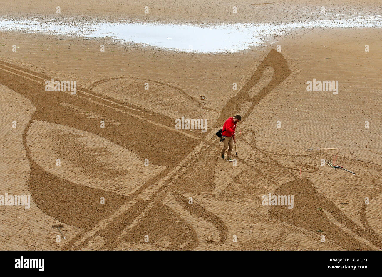 Jamie Wardley who is part of the Sand in Your Eye team, draws a violin ...