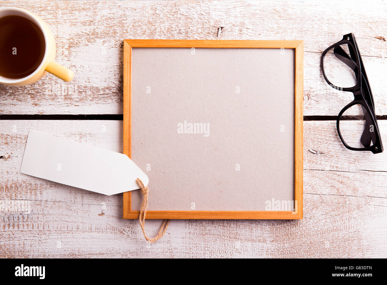 Empty picture frame, eyeglasses and cup of tea Stock Photo - Alamy