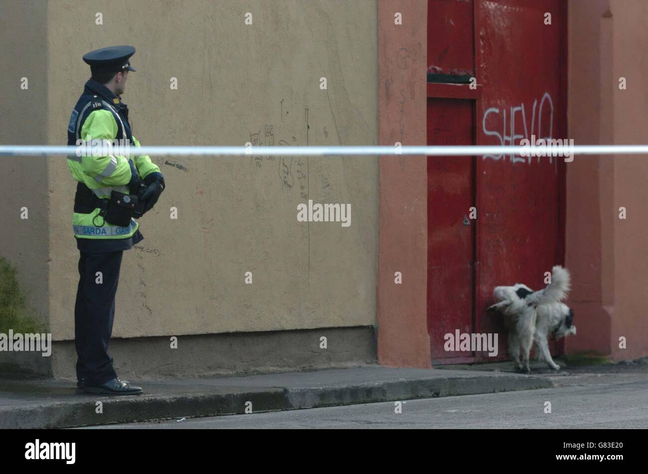 A Garda stands watch over the scene of a shooting, where a man was shot ...