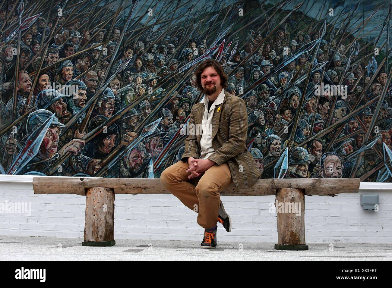 Artist Chris Rutterford poses with a mural that he created for the ...