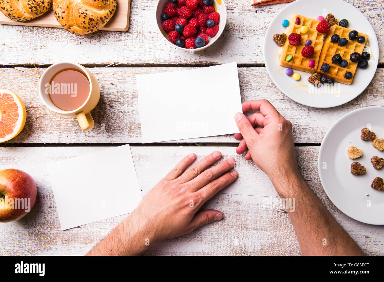 Hands of man holding empty greeting card. Breakfast meal Stock Photo ... Hands of man holding empty greeting card. Breakfast meal Stock Photo ...