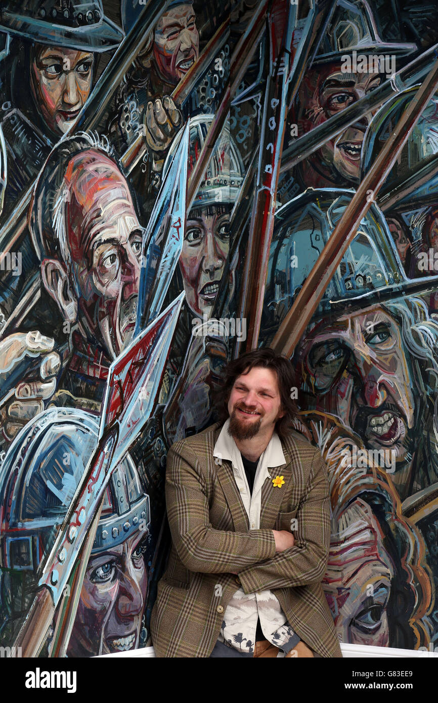 Artist Chris Rutterford poses with a mural that he created for the ...