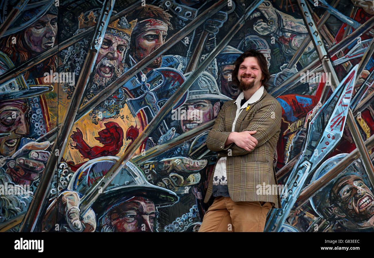 Artist Chris Rutterford poses with a mural that he created for the ...