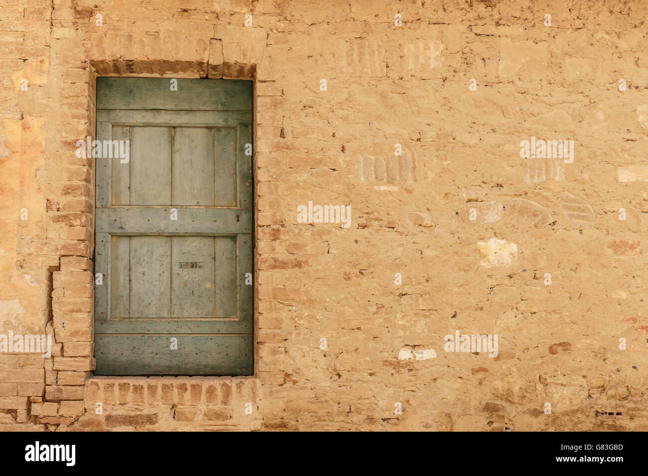 Rustic wooden door in colour color in random stonework - background ...