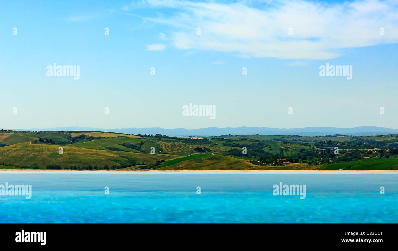 Rolling tuscan hills beyond Infinity pool in Tuscany glorious sunshine ...