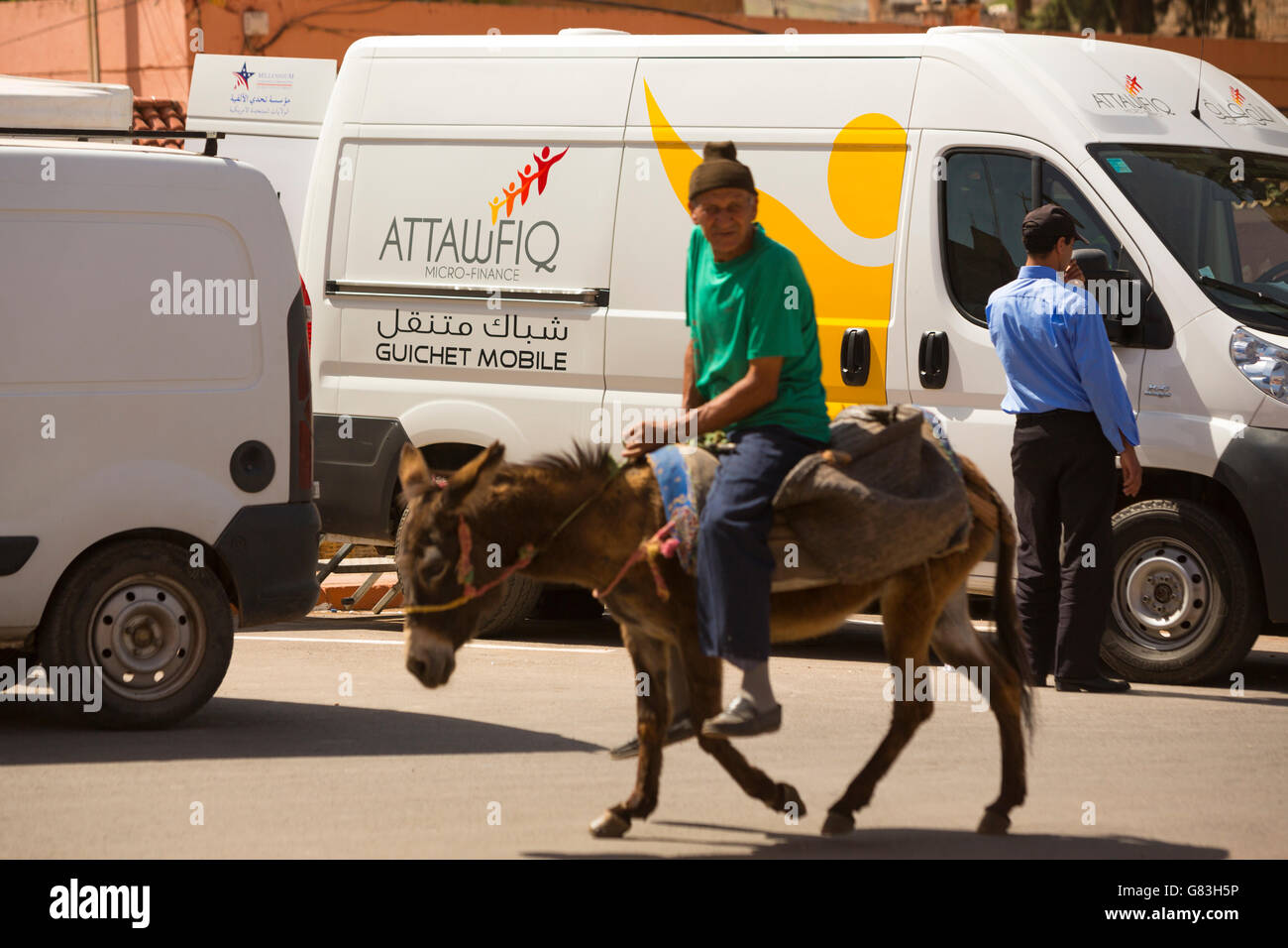 Morocco man riding donkey village north africa hi-res stock photography ...