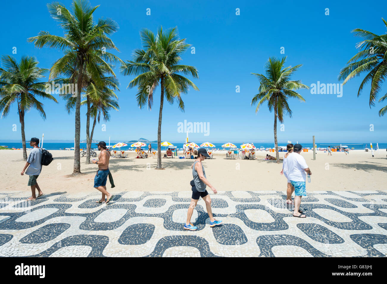 RIO DE JANEIRO - FEBRUARY 28, 2016: Beachgoers pass on the beachfront ...